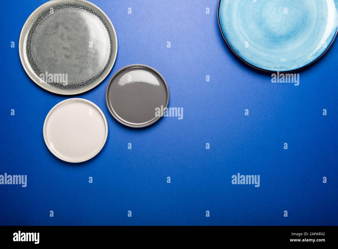 Different Ceramic Empty Blue and Grey Plates on Blue Background, Top ...