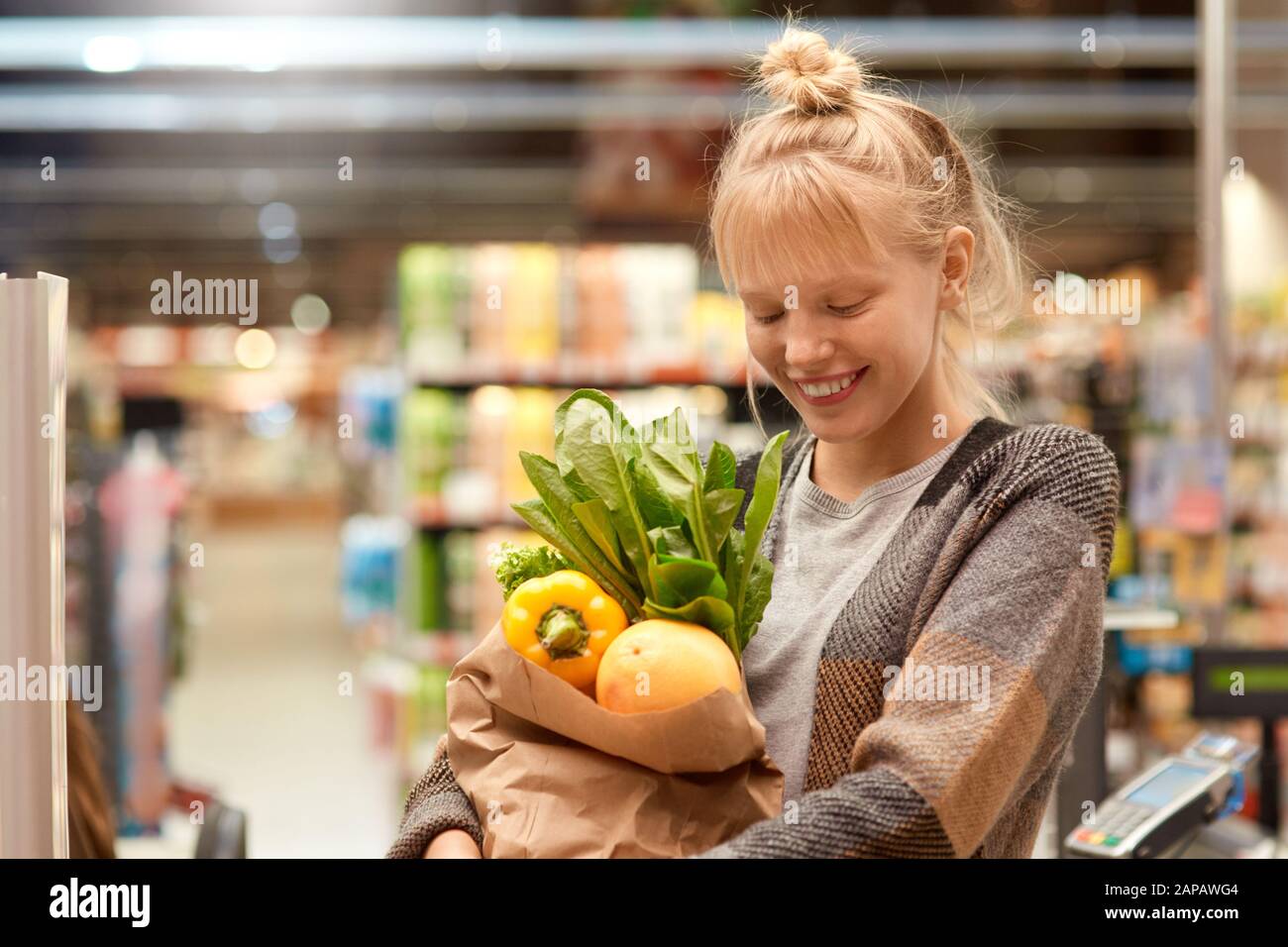 Just walk out shopping technology. Woman at the supermarket standing ...