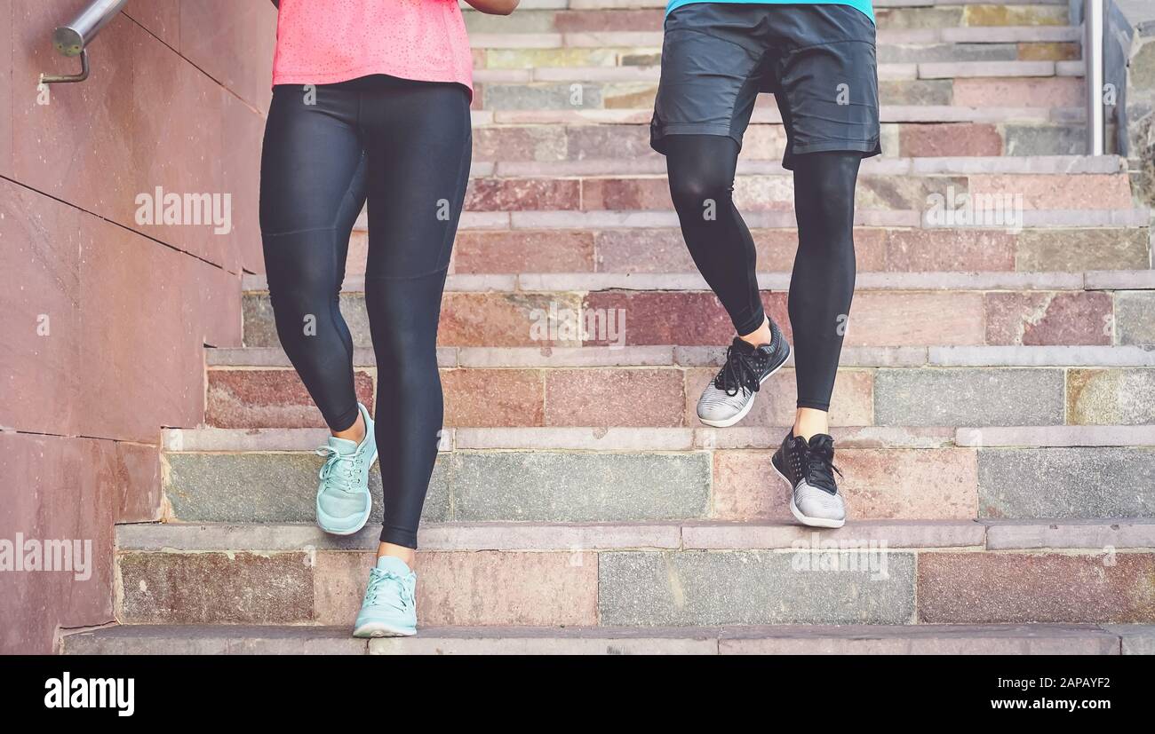 Fit couple doing steps workout session outdoor - Happy friends training ...