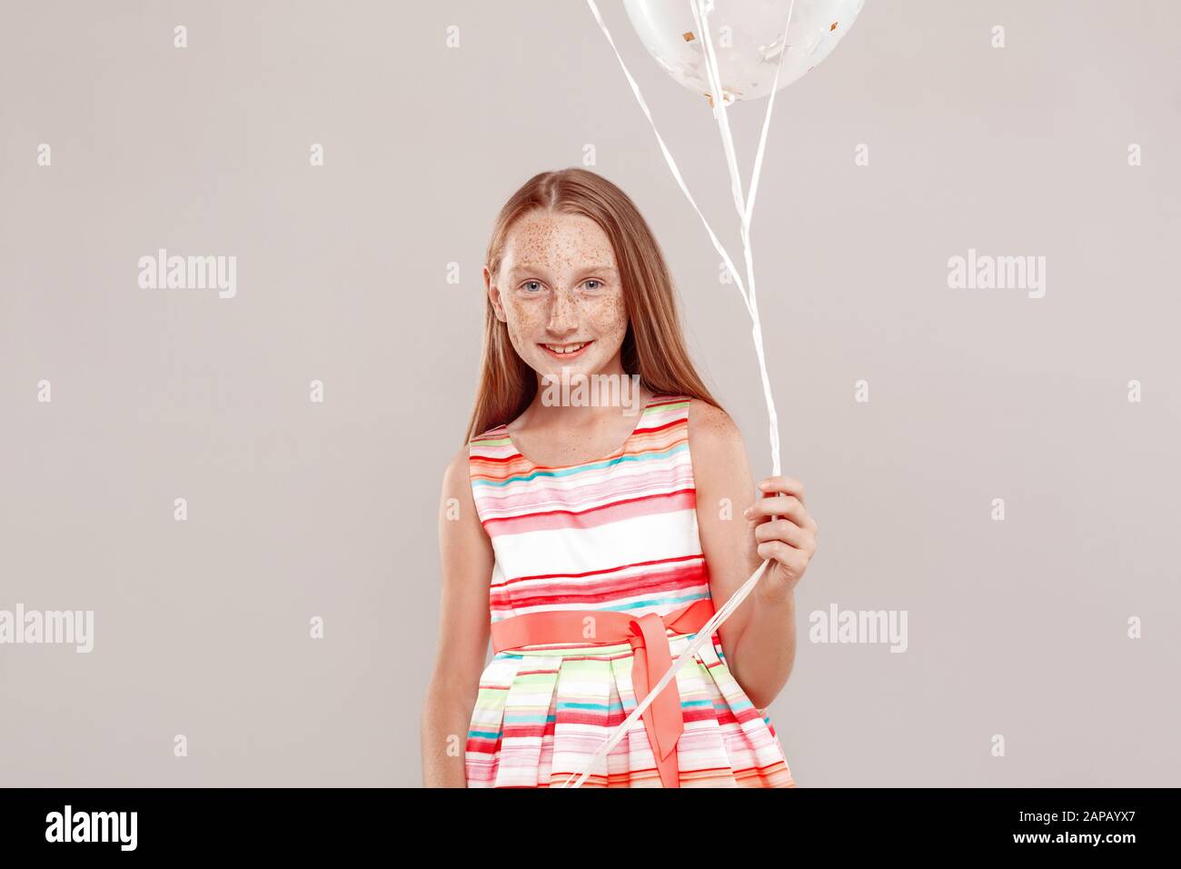Inclusive Beauty. Girl with freckles in dress standing isolated on grey ...