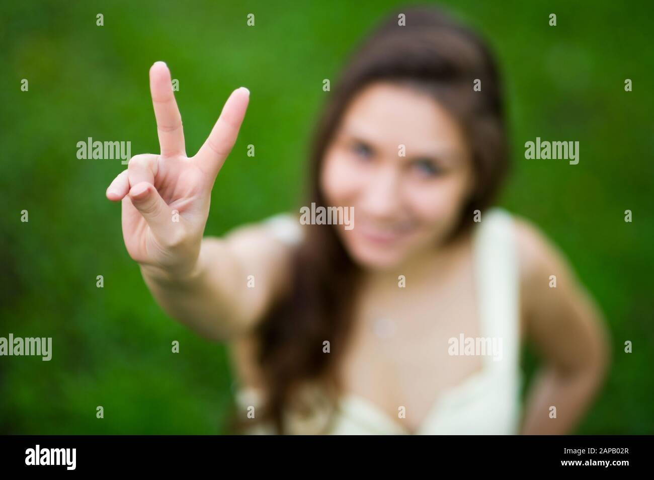 young girl shows peace sign with her fingers Stock Photo - Alamy