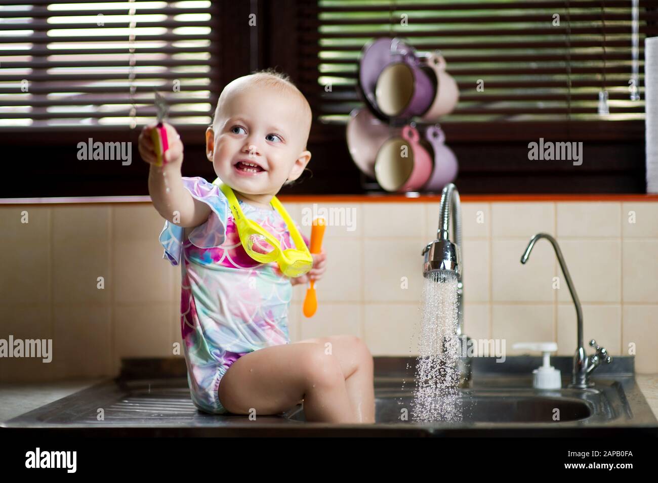 Child girl swimsuit kitchen hi-res stock photography and images - Alamy