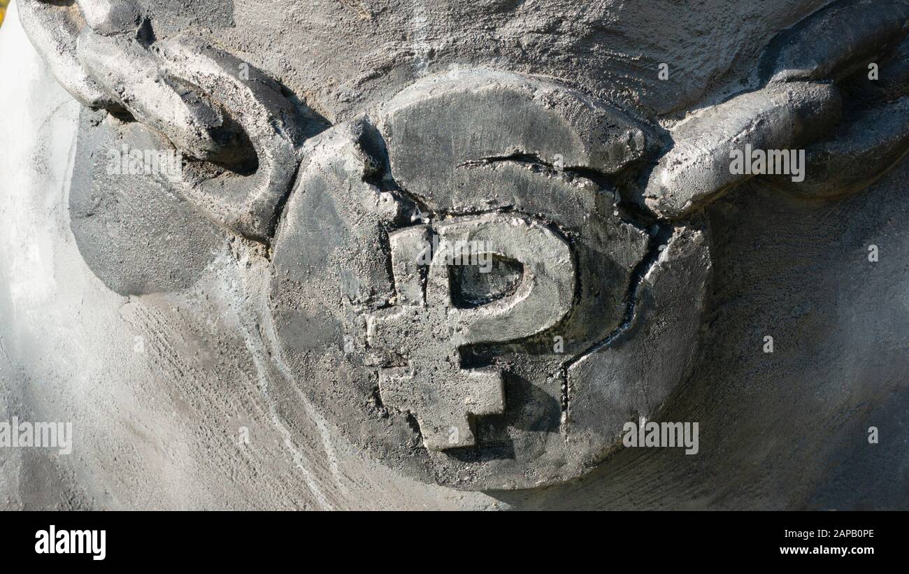 The sign of the Russian ruble cracked and hanging on chains is made of ...