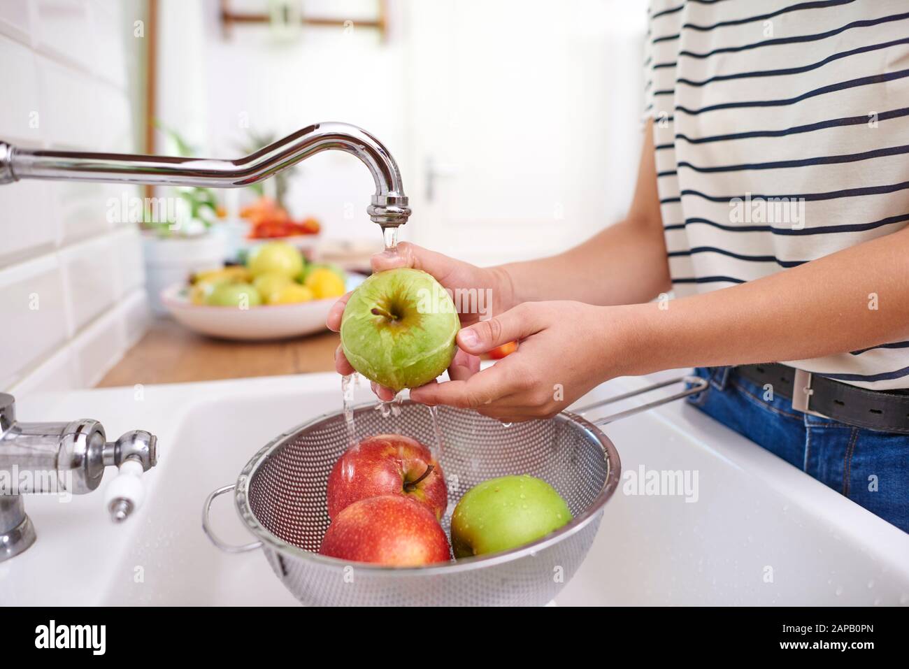 Woman washing apple hi-res stock photography and images - Alamy