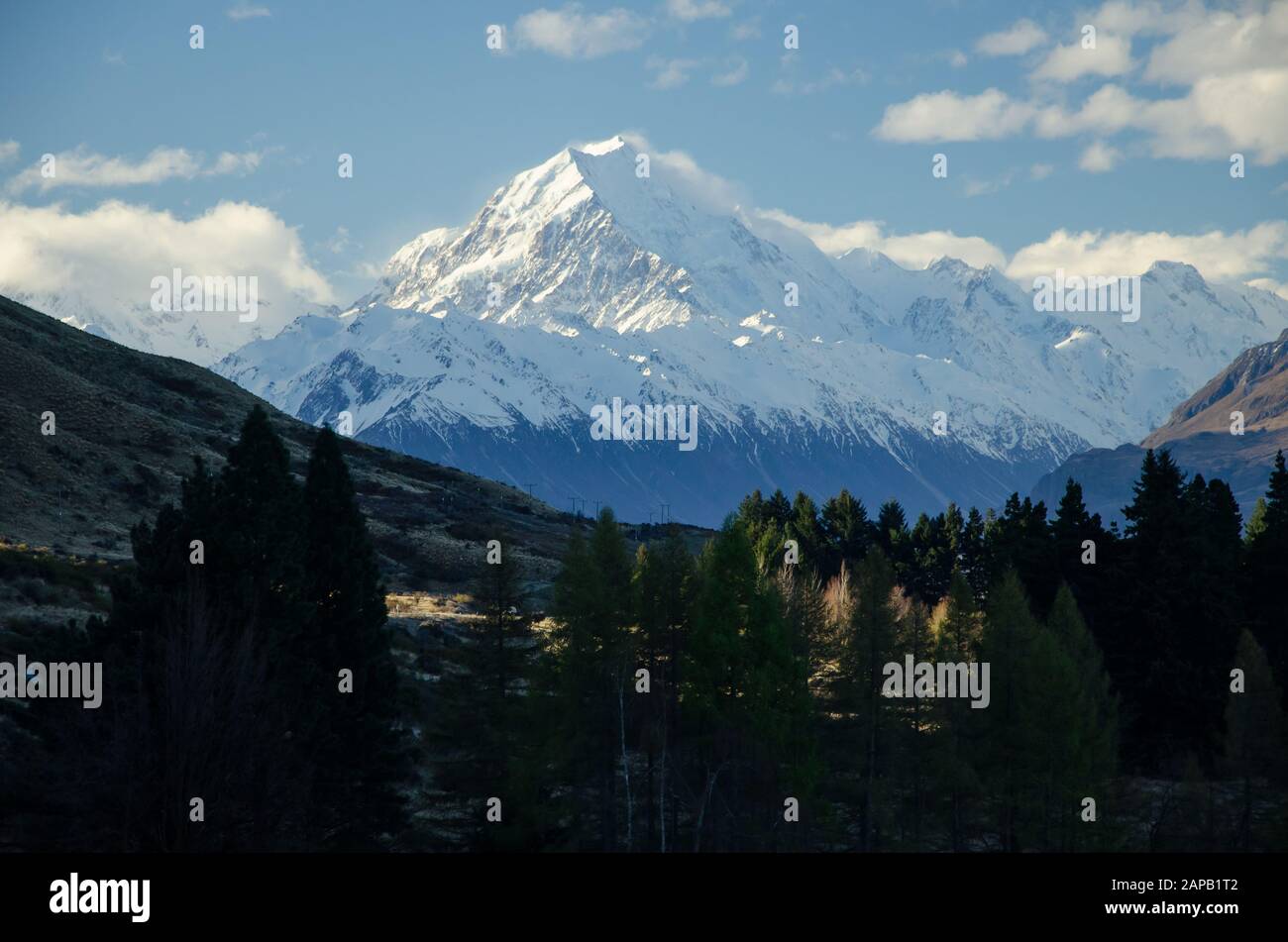 Snow covered Mount Cook with blue sky and white clouds, South Island ...