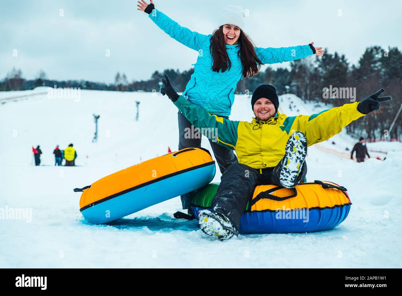 Couple snow tubing hi-res stock photography and images - Alamy