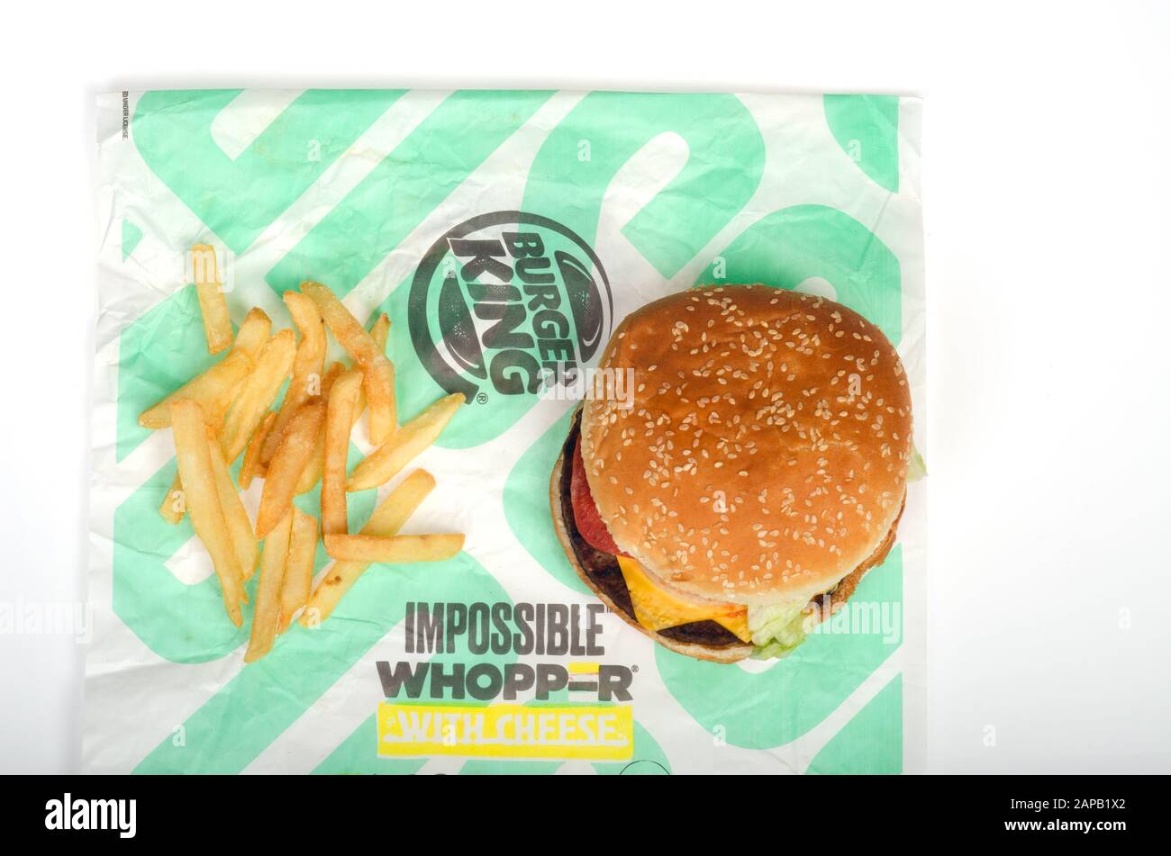 Burger King Impossible Whopper with fries on wrapper Stock Photo - Alamy