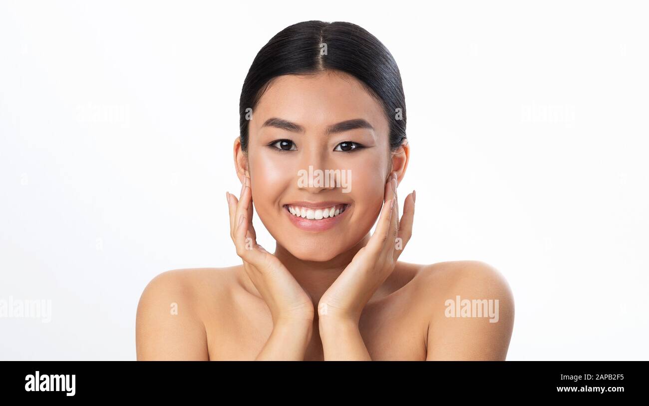 Face lifting concept. Happy girl touching soft smooth skin Stock Photo ...