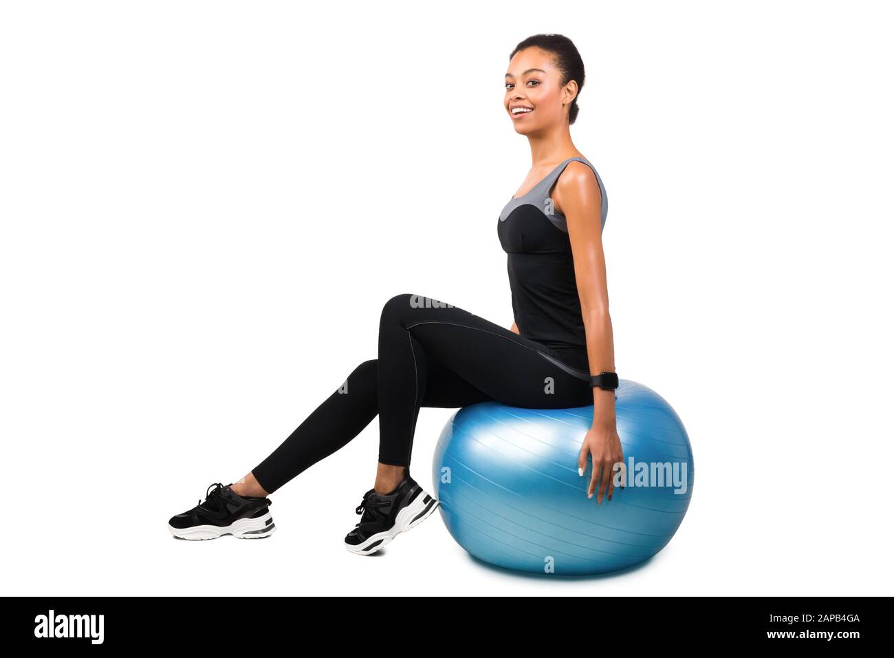 African American Woman Sitting On Fitball Posing Over White Background ...