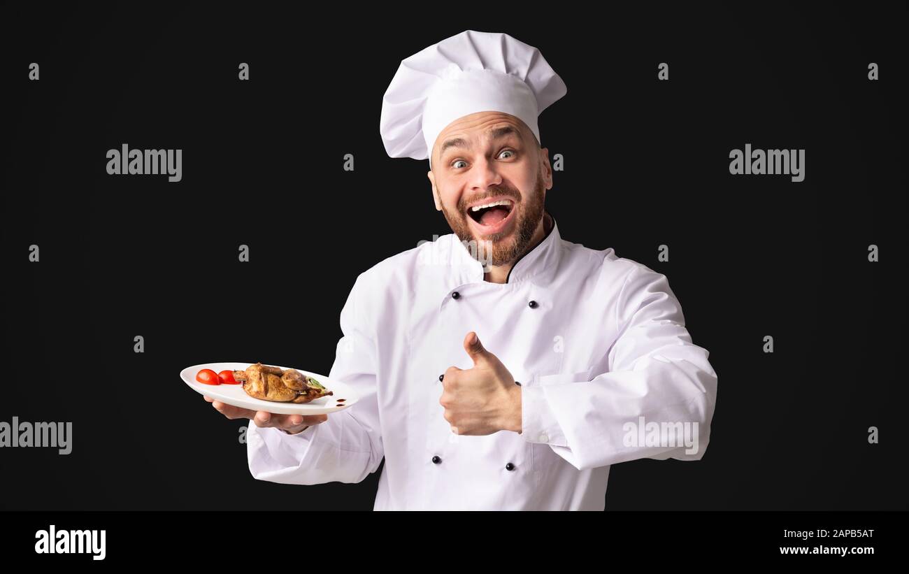 Excited Chef Showing Chicken Dish Gesturing Thumbs-Up, Black Background ...