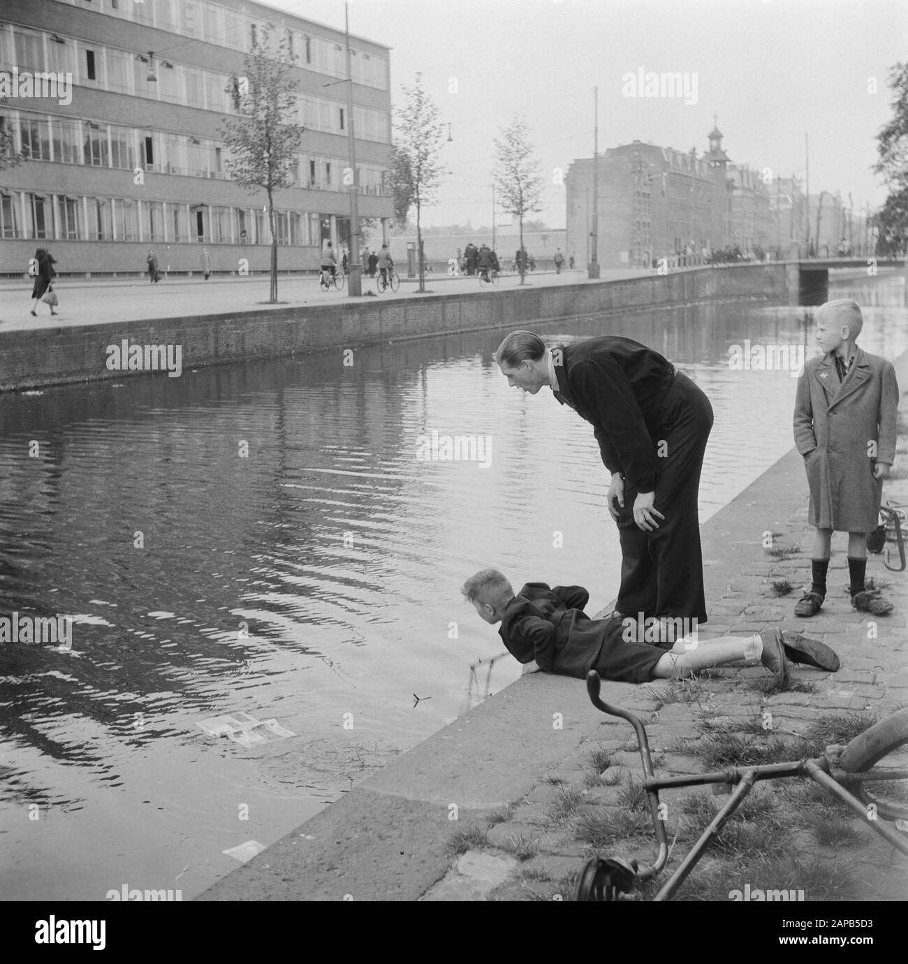 Amsterdam. Liberation. Street images [Man and boy looking in the water ...