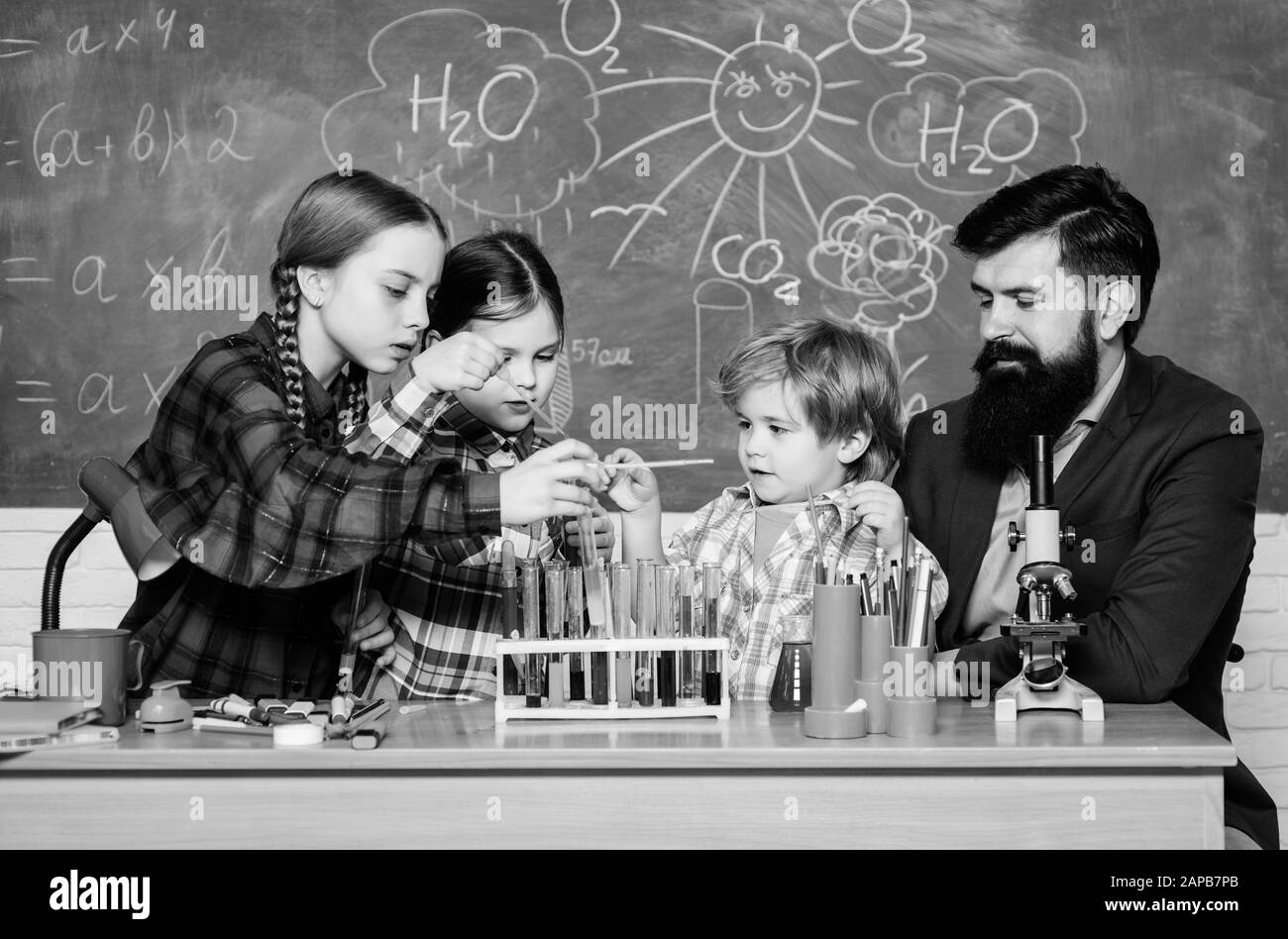 Little kids learning chemistry in school laboratory. school kids ...