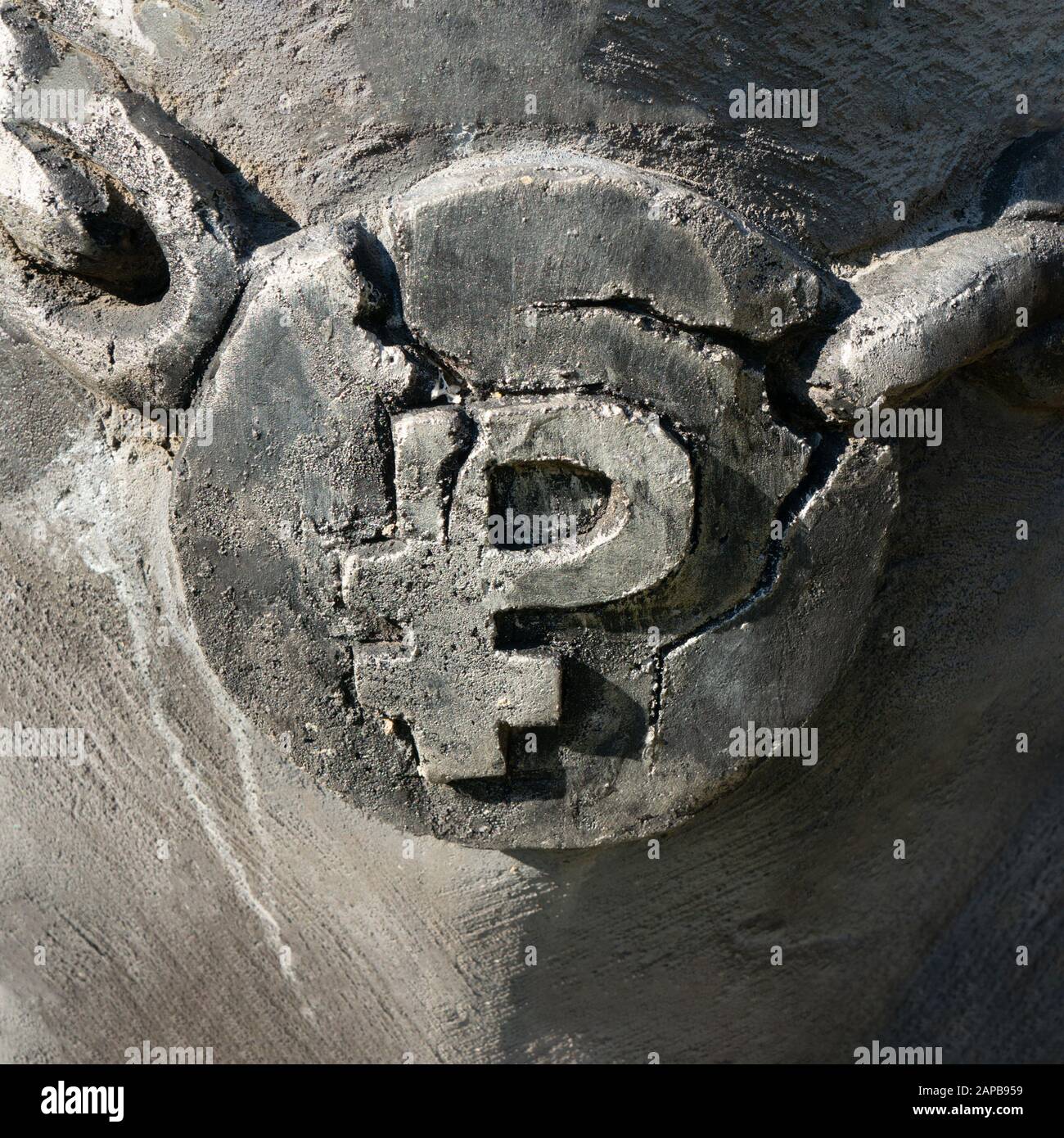 The sign of the Russian ruble cracked and hanging on chains is made of ...