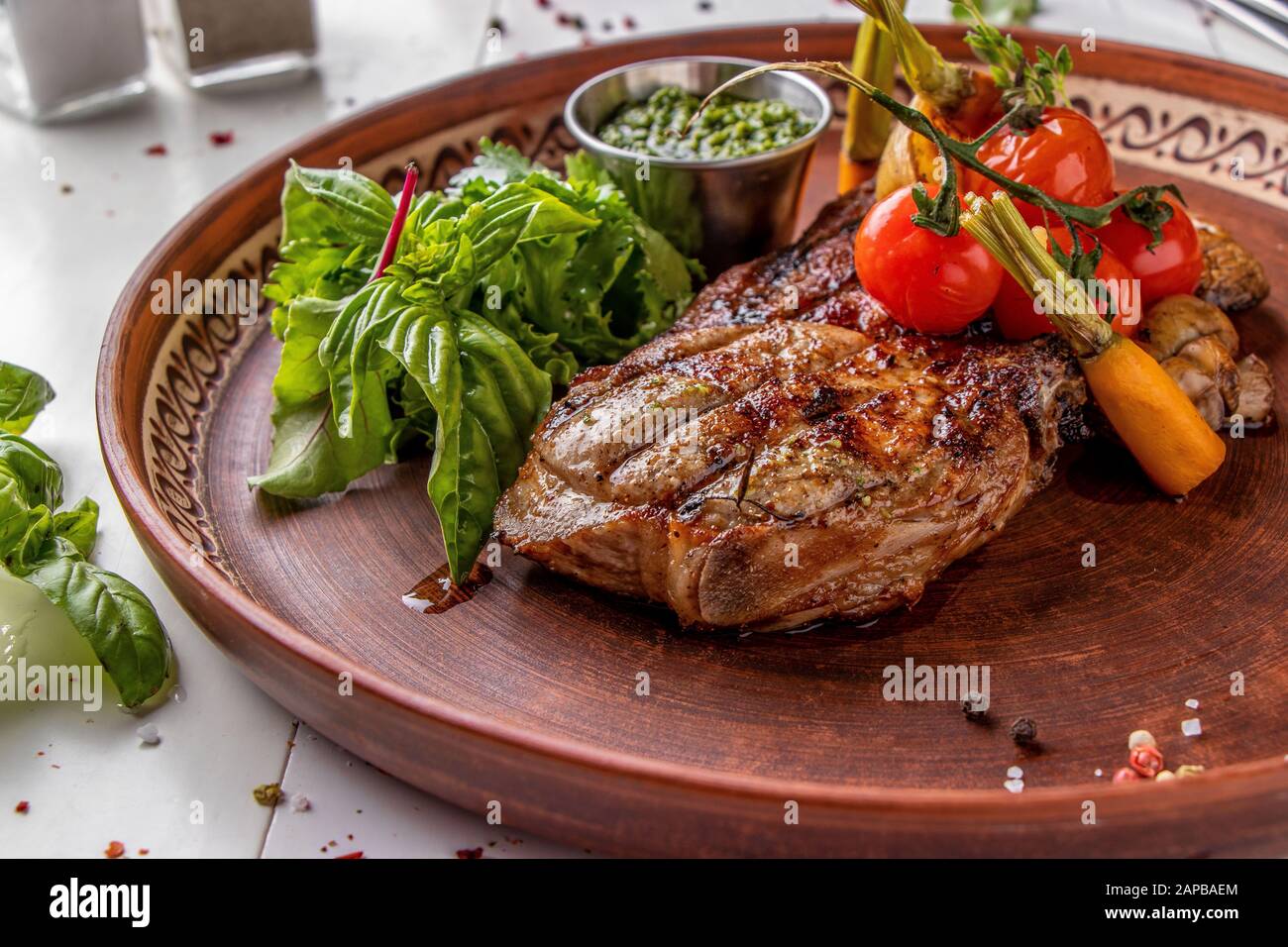 Pork entrecote served with grilled vegetables, mushrooms and pesto ...