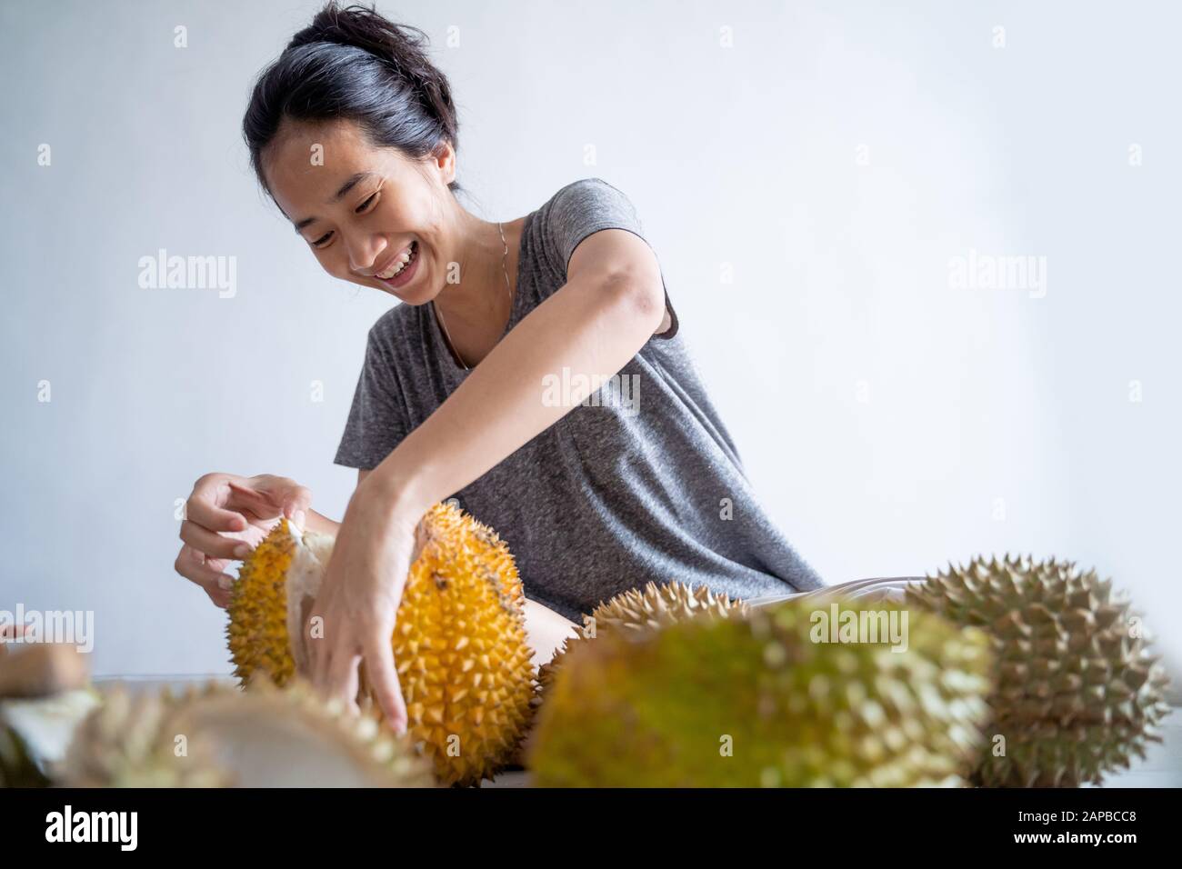 asian woman eating durian fruit Stock Photo - Alamy