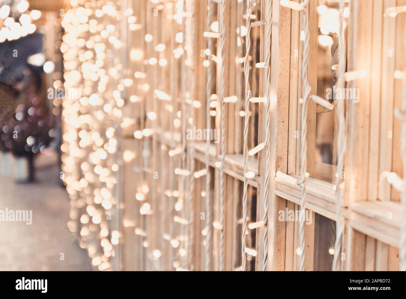 Yellow garland of lights on the window frames of a restaurant or cafe ...