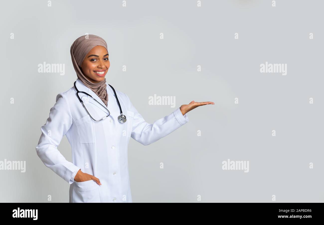 Young Black Female Doctor Holding Invisible Item On Her Palm Stock ...