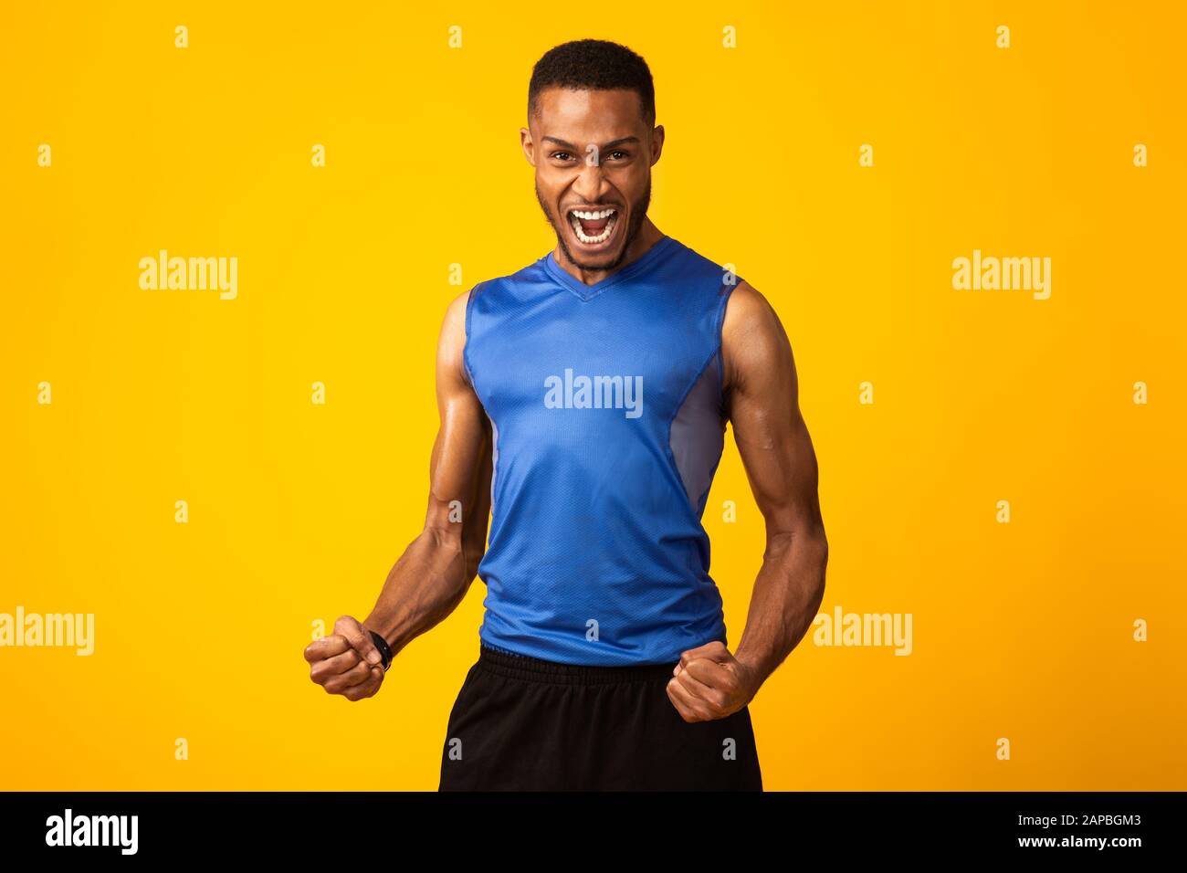 Excited black guy celebrating triumph gesturing at studio Stock Photo ...