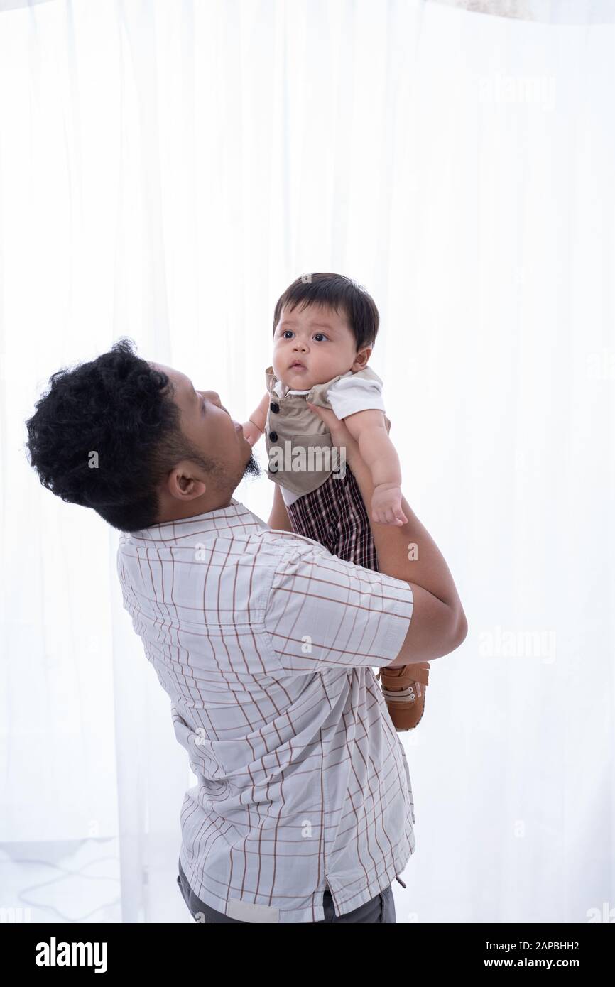 young father is carrying his son Stock Photo - Alamy