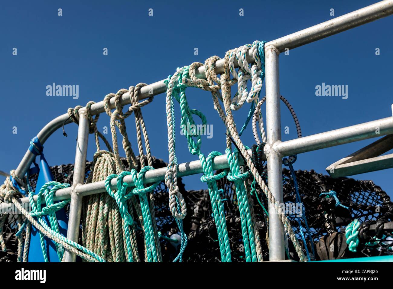 Ropes and Lobster Pots tied to the railings on a quay Stock Photo - Alamy
