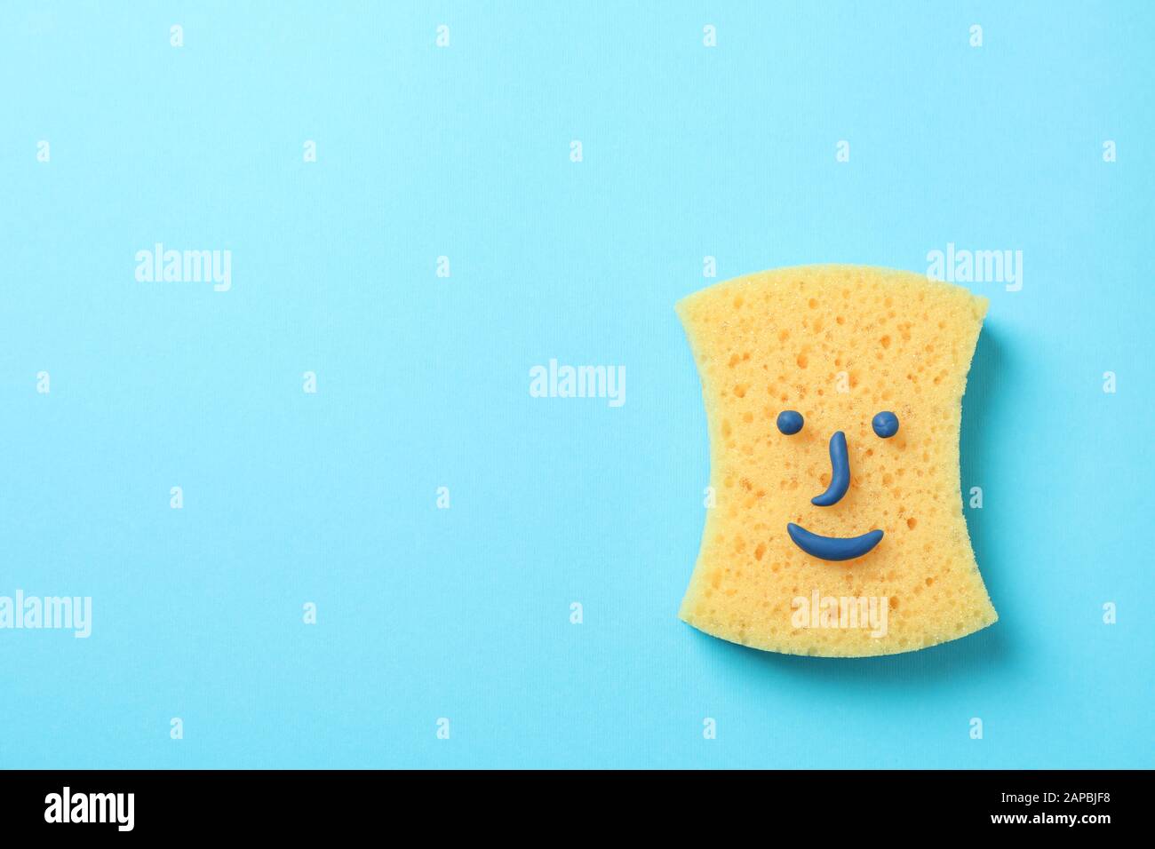 Sponge with smiley face on blue background, top view Stock Photo - Alamy
