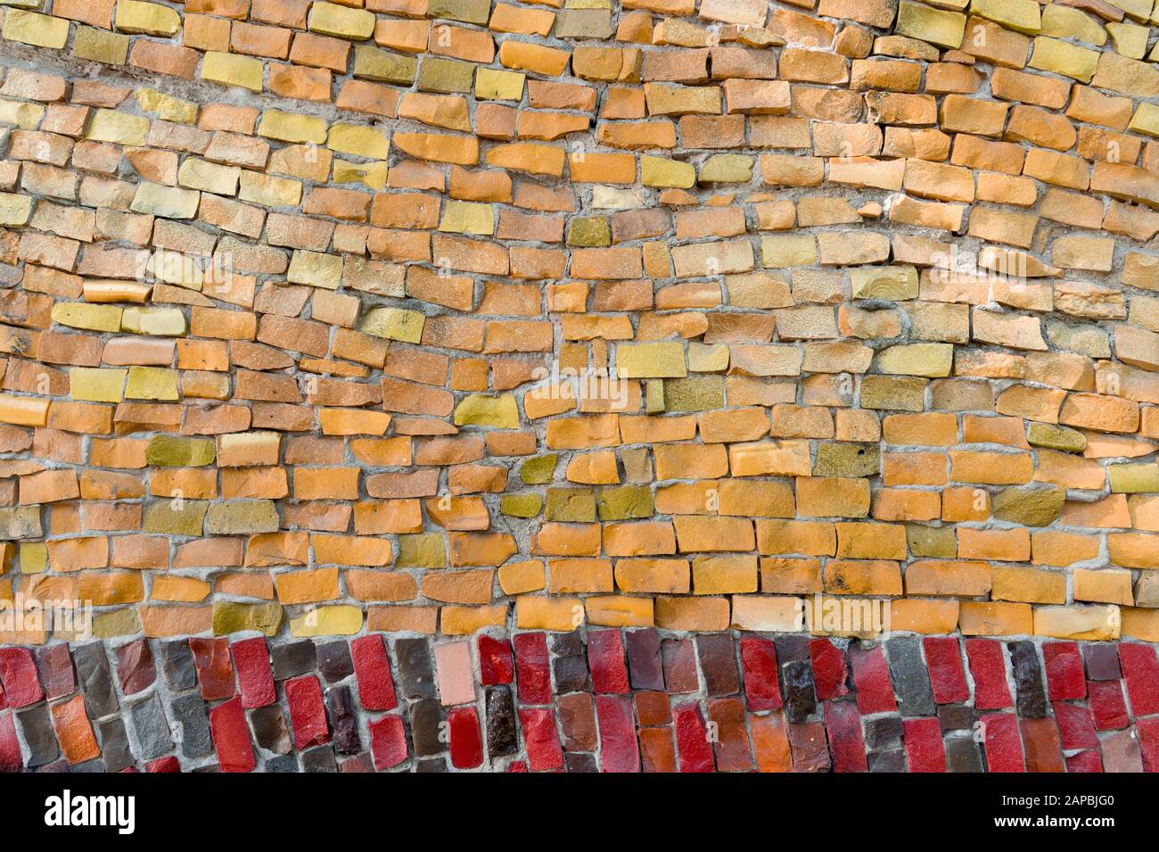 surface of old crumbling abstract decorative mosaic with orange and red ...