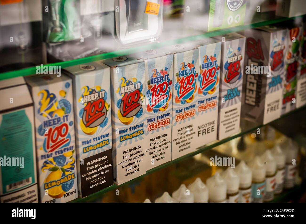 A selection of flavored vaping supplies on display in the window of a ...