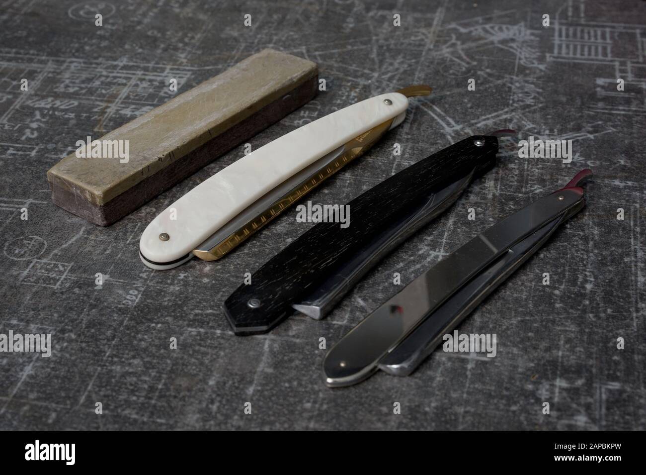 three different traditional razors and a sharpening stone Stock Photo ...