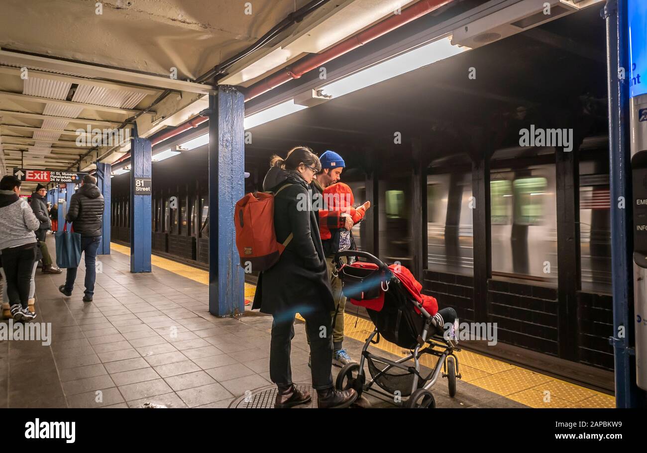 Family waits for a train at the West 81st Street station in the New ...