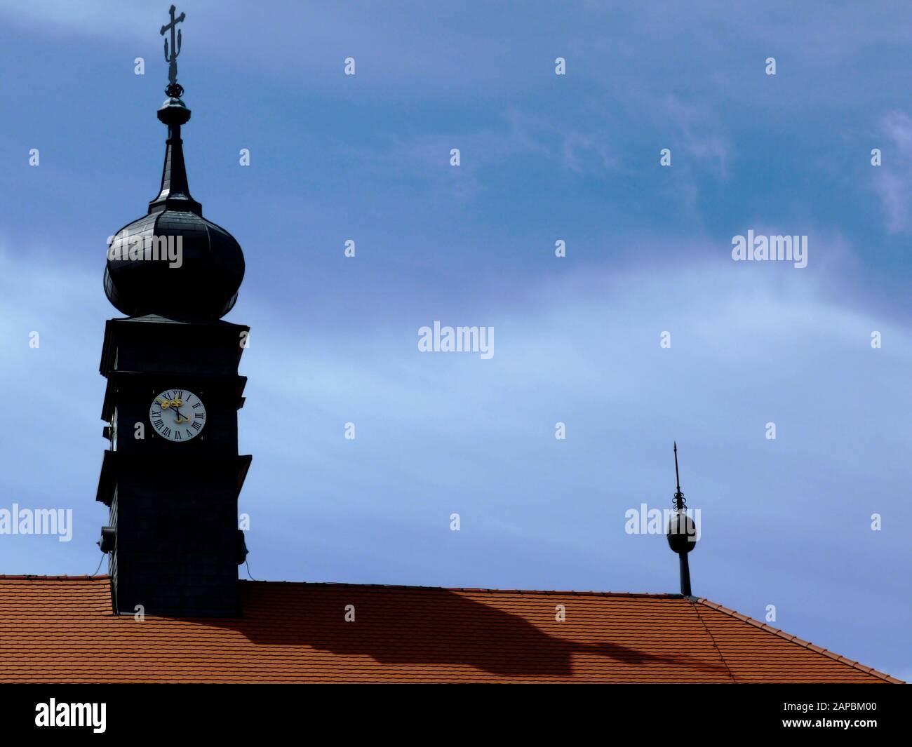 Light brown clay tile roof and black metal plate covered clock tower ...