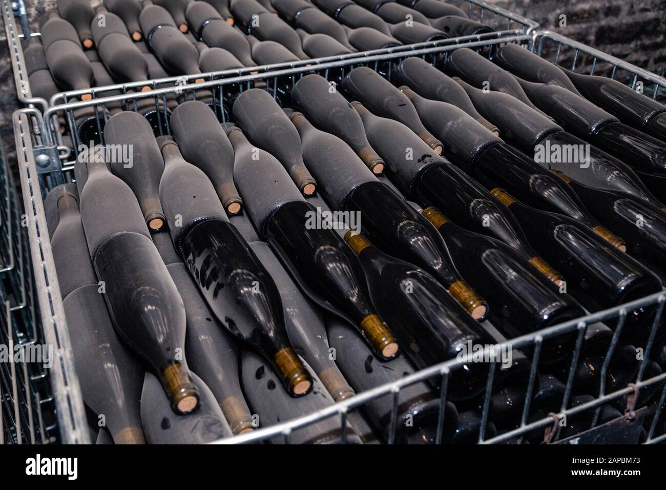 Ancient wine bottles resting, aging, dusting in underground cellar in ...