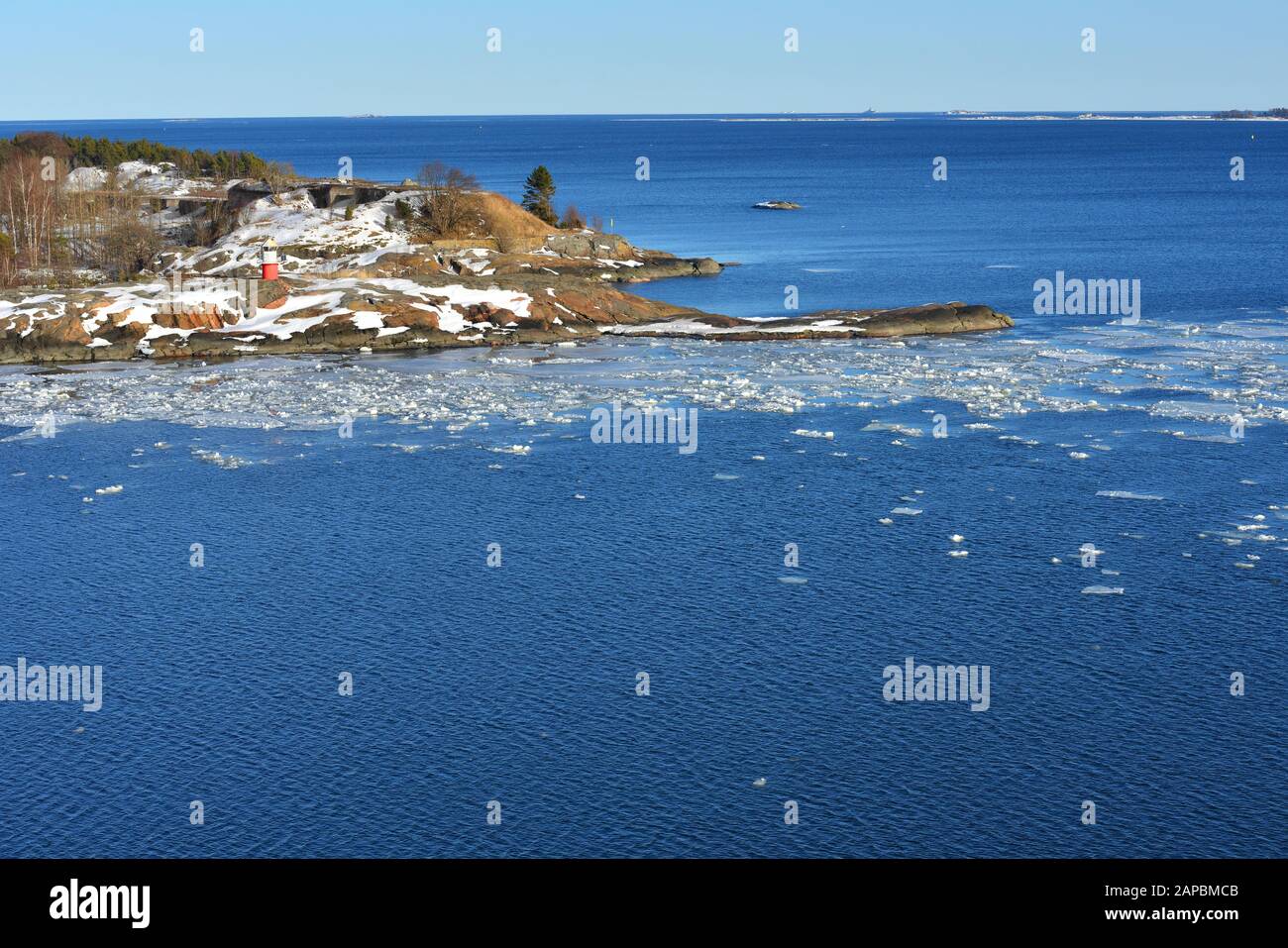 Baltic Sea with floating ice near island coast of Helsinki Archipelago ...
