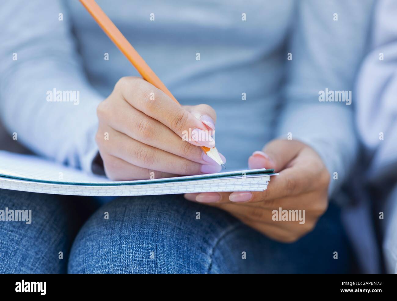 Cropped of student girl taking notes, using notepad and pencil Stock ...