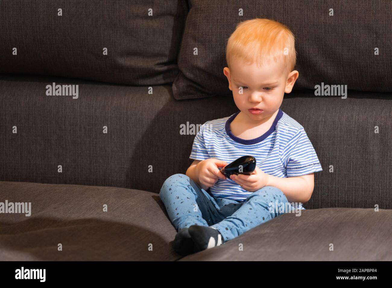 Little boy watching tv Stock Photo - Alamy