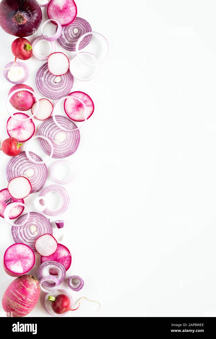 A top down vertical view of a border of overlapping slices of red onion ...