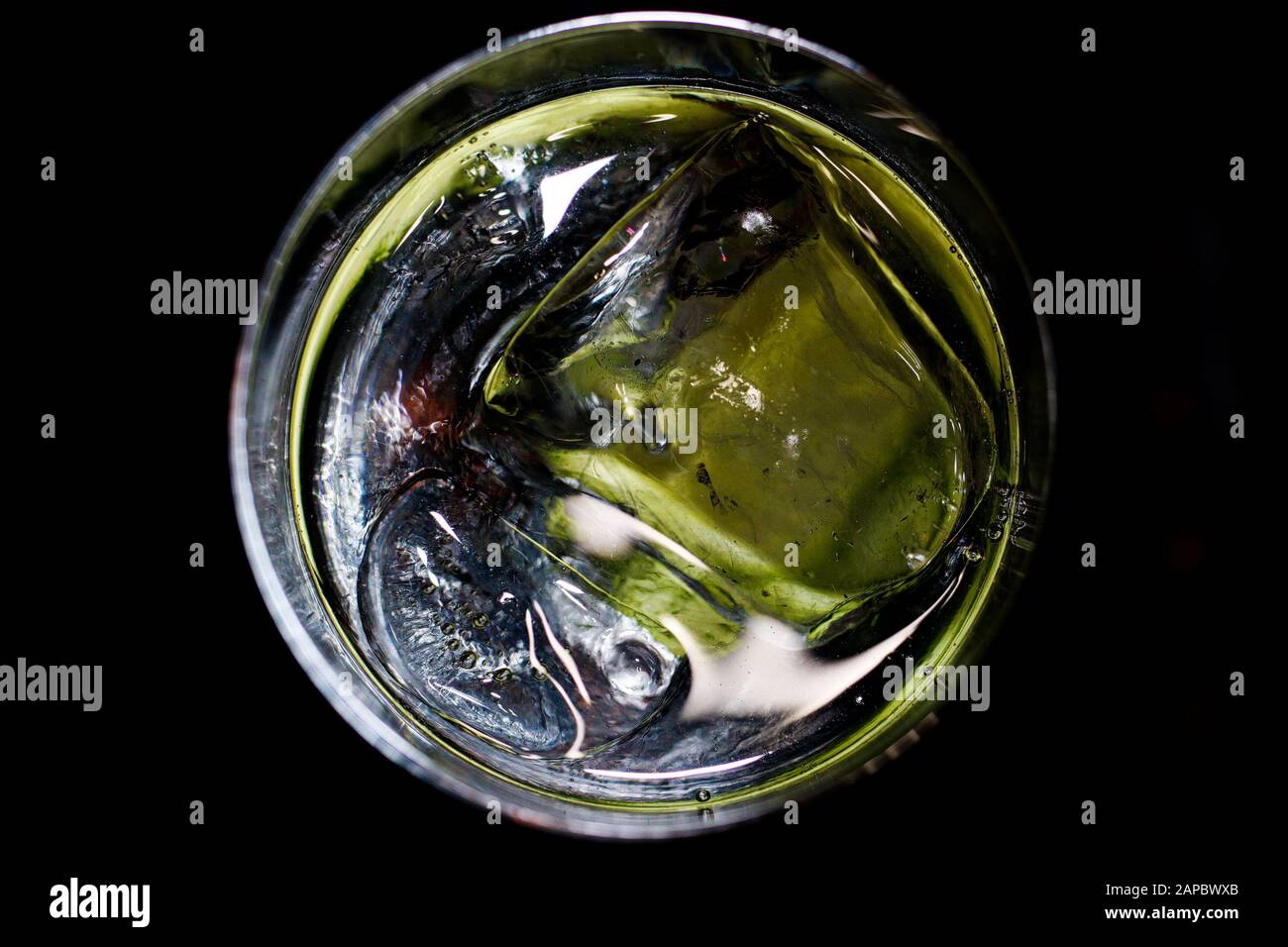 Gin tonic: View from above on isolated round cocktail glass rim with ...