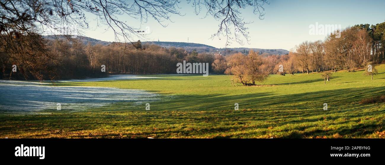 First melting snow on green field in germany outdoor Stock Photo - Alamy