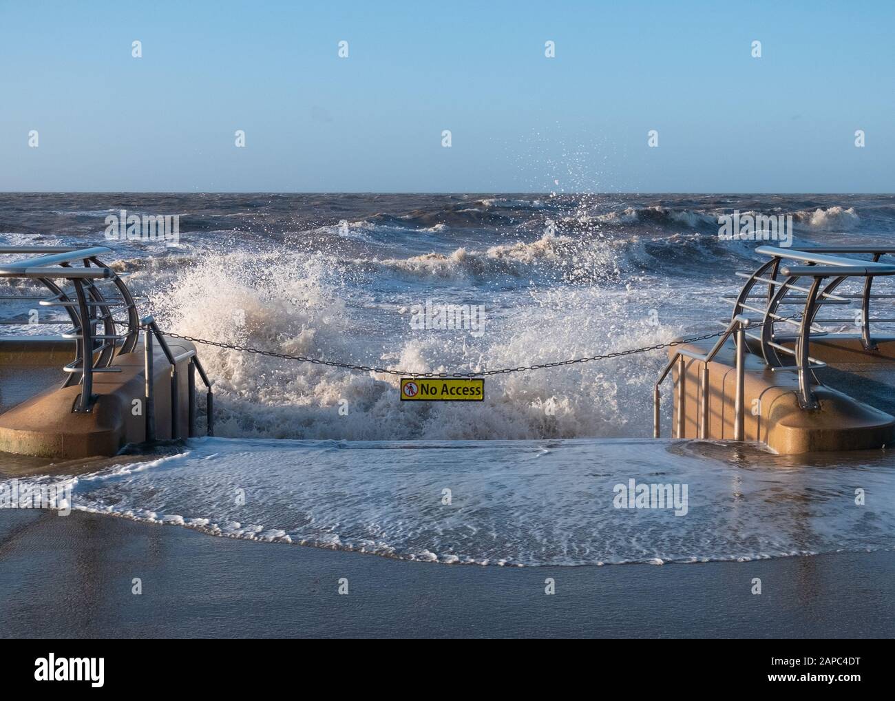 No entry signs to the seafront at Blackpool, at high tide with waves ...