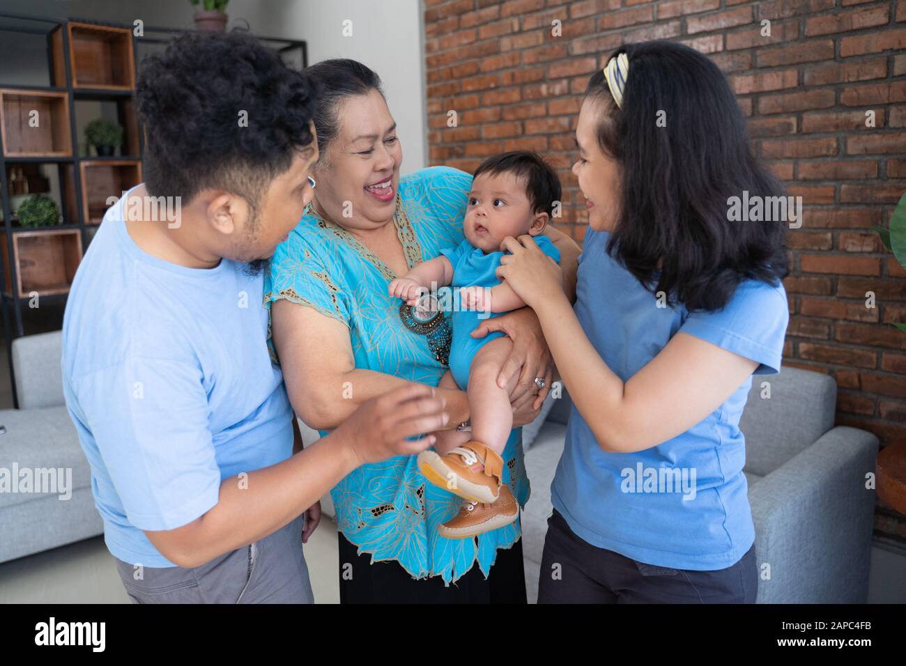 father mother grandmother and grandson joking together Stock Photo - Alamy