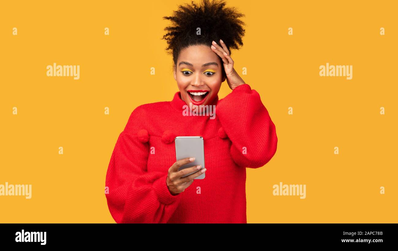 Black girl using mobile phone at studio Stock Photo - Alamy