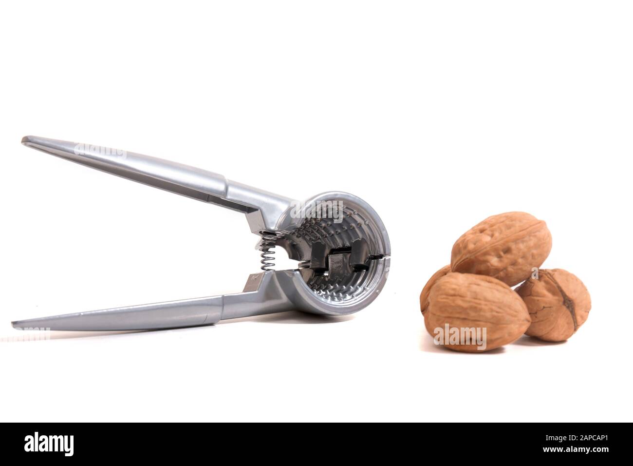View of a metal tool for cracking nuts isolated on a white background ...