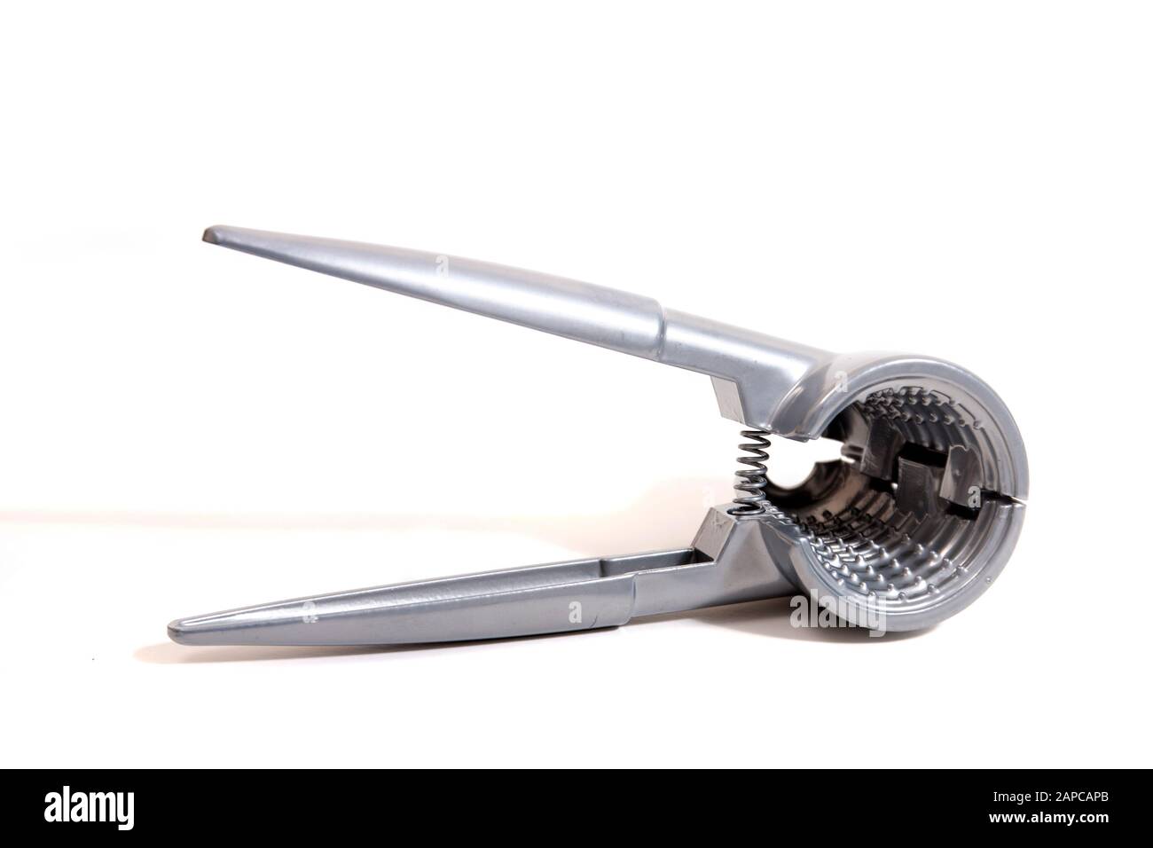 View of a metal tool for cracking nuts isolated on a white background ...