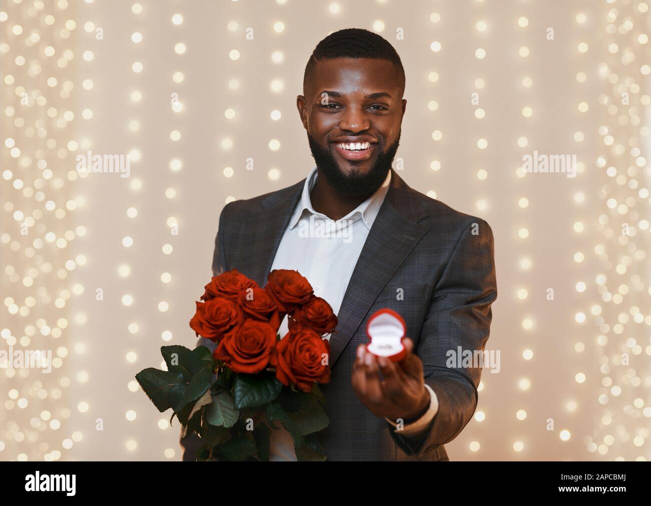 Handsome guy holding flowers hi-res stock photography and images - Alamy