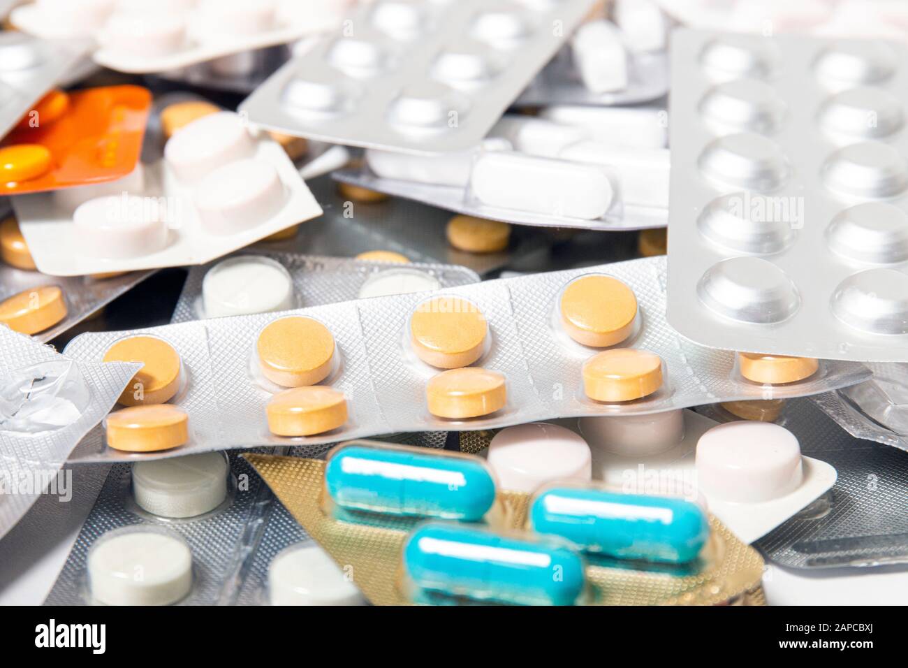 Assorted mix of pills over a white background Stock Photo - Alamy