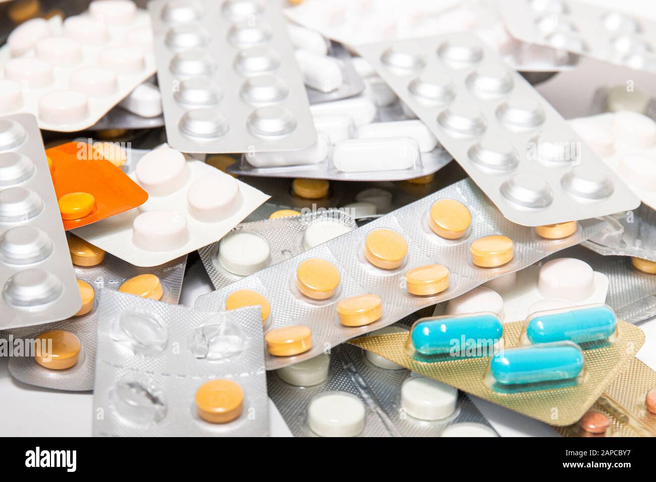 Assorted mix of pills over a white background Stock Photo - Alamy