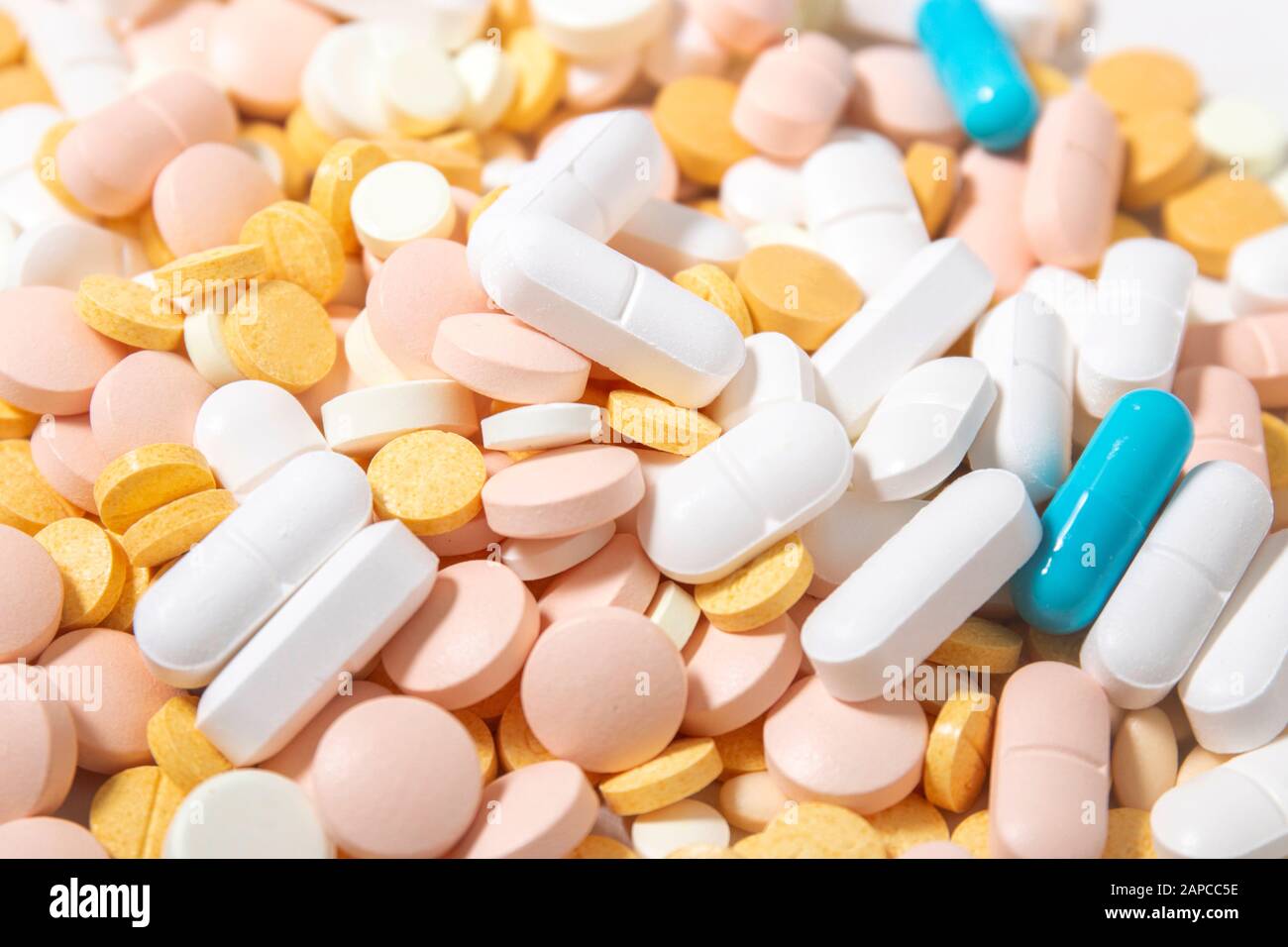 Assorted mix of pills over a white background Stock Photo - Alamy