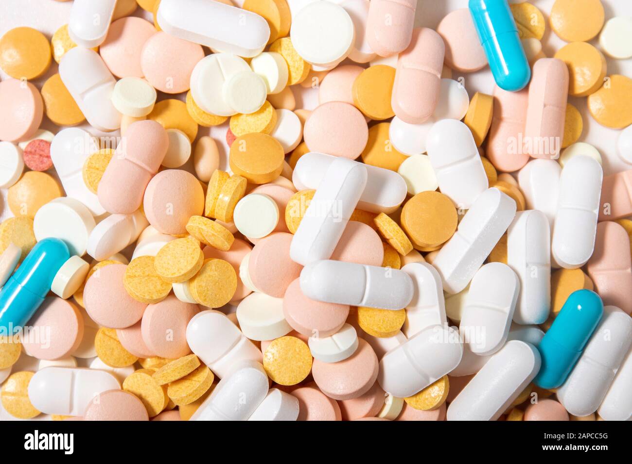 Assorted mix of pills over a white background Stock Photo - Alamy