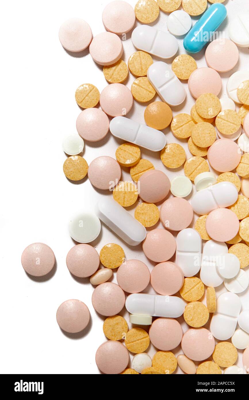 Assorted mix of pills over a white background Stock Photo - Alamy