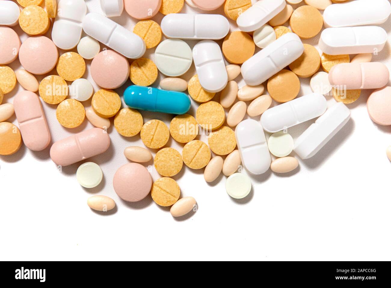 Assorted mix of pills over a white background Stock Photo - Alamy