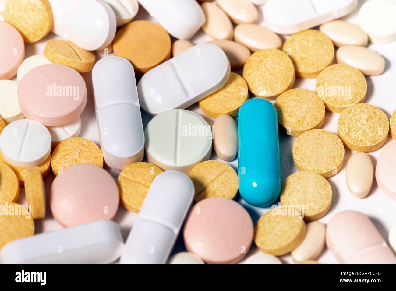Assorted mix of pills over a white background Stock Photo - Alamy